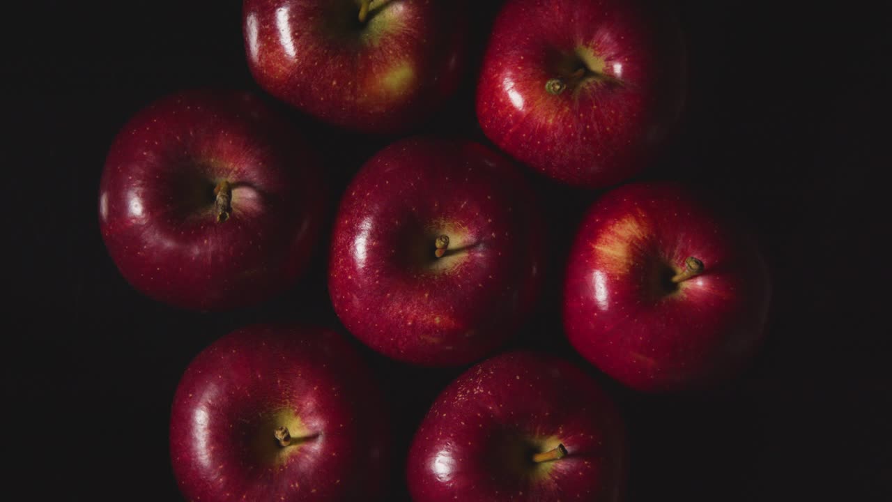 Overhead Studio Shot Of Circle Of Red Apples Revolving Against Black ...