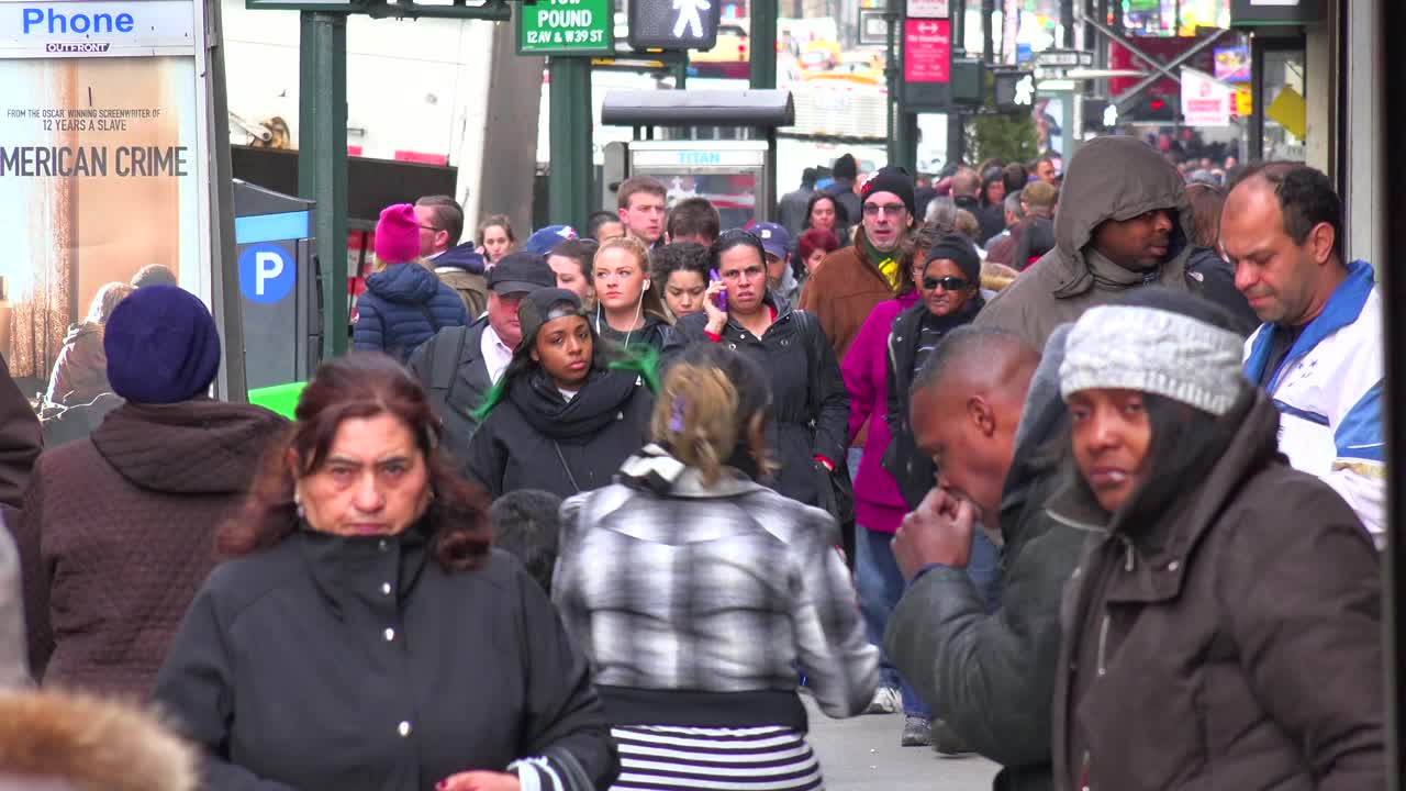 Crowds Of People Pass A Homeless Person On The Streets Of Manhattan New ...