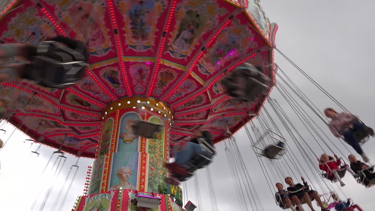 A Rotating Elevated Carnival Ride Gives Folks A Thrill At An Amusement ...