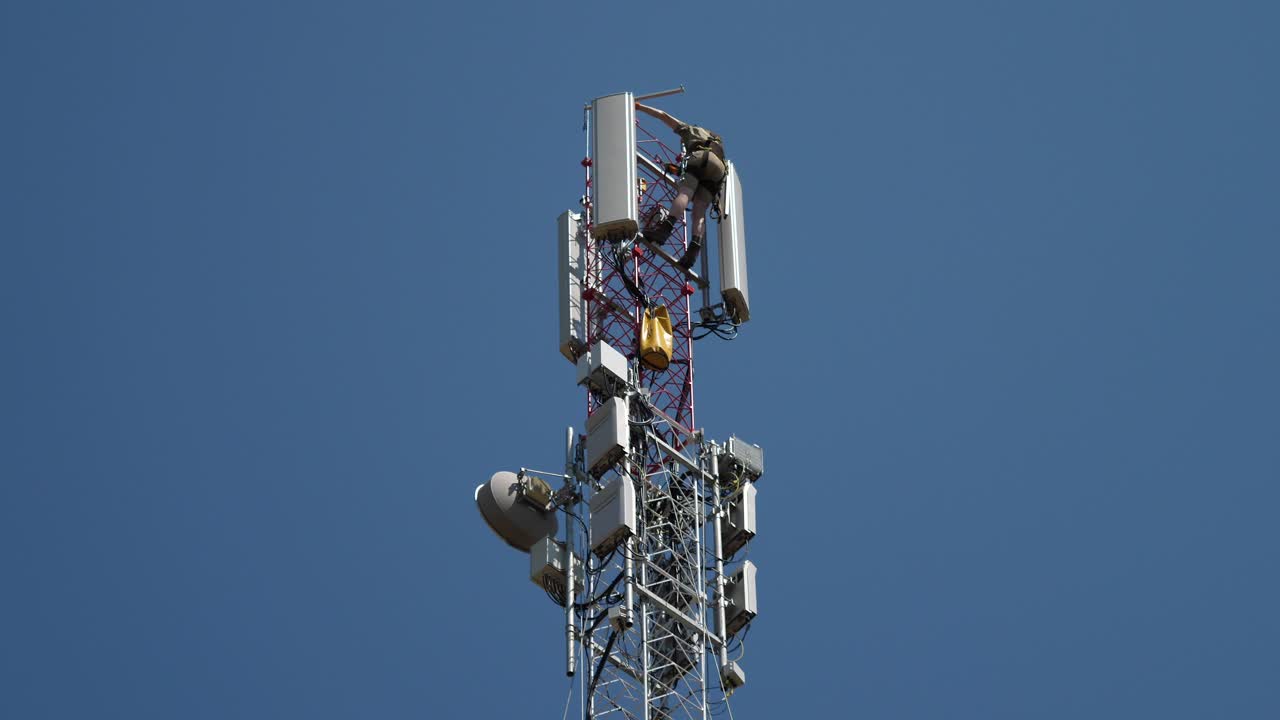 Industrial Alpinist Installing Telecom Antennas On Communication Tower ...