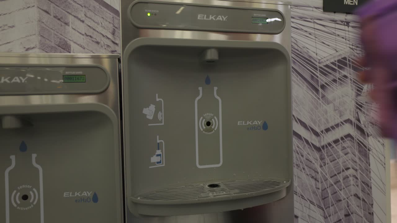 Person Using Elkay Wall Mounted Water Bottle Refilling Station At JFK ...