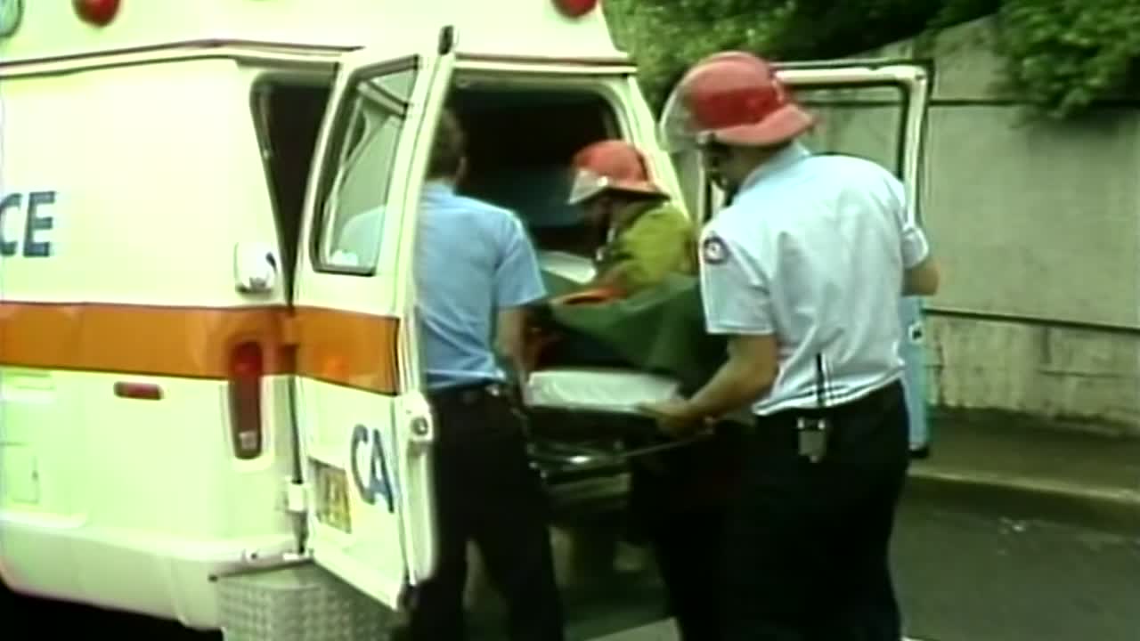 PARAMEDICS LOADING VICTIM INTO THE BACK ON AN AMBULANCE FROM THE 1980S ...