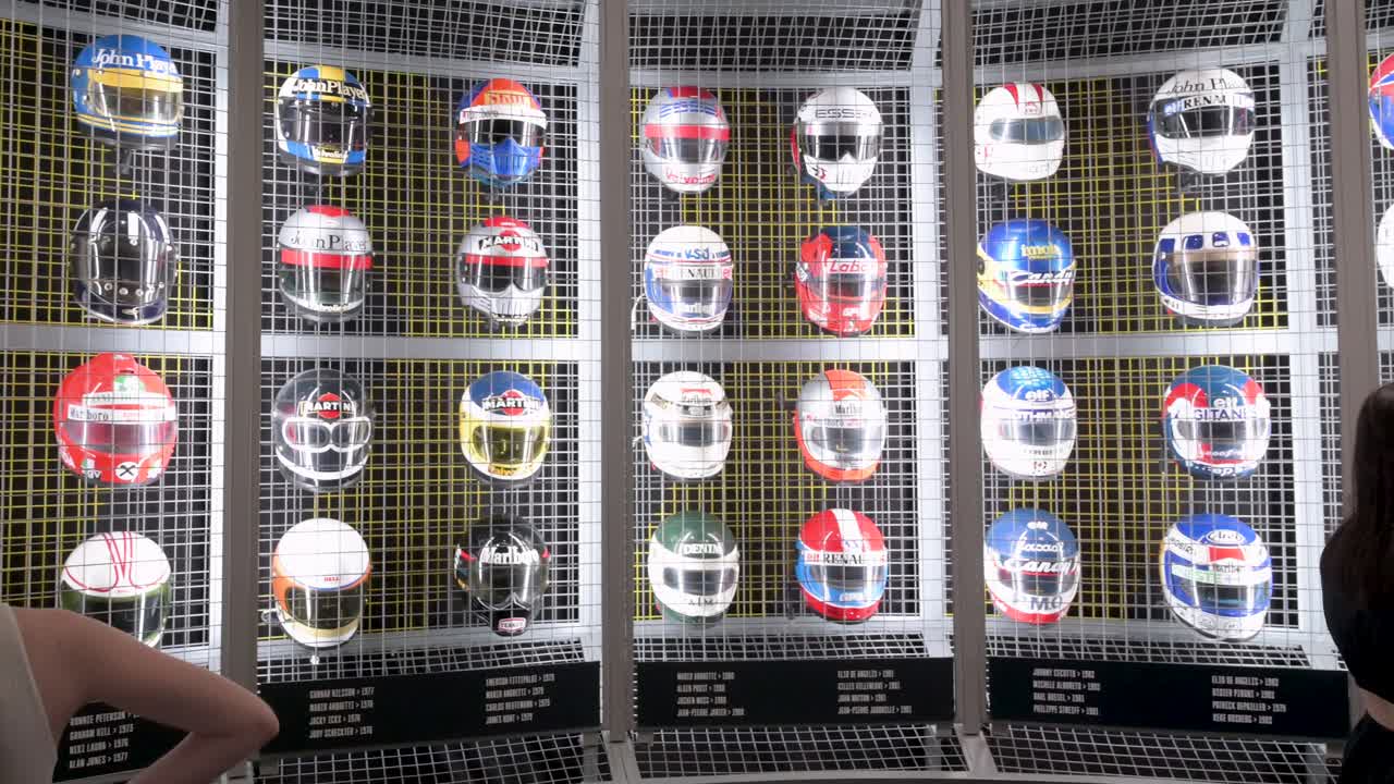 Visitors Take Photos Of Displayed F1 Driver Helmets During The World's ...