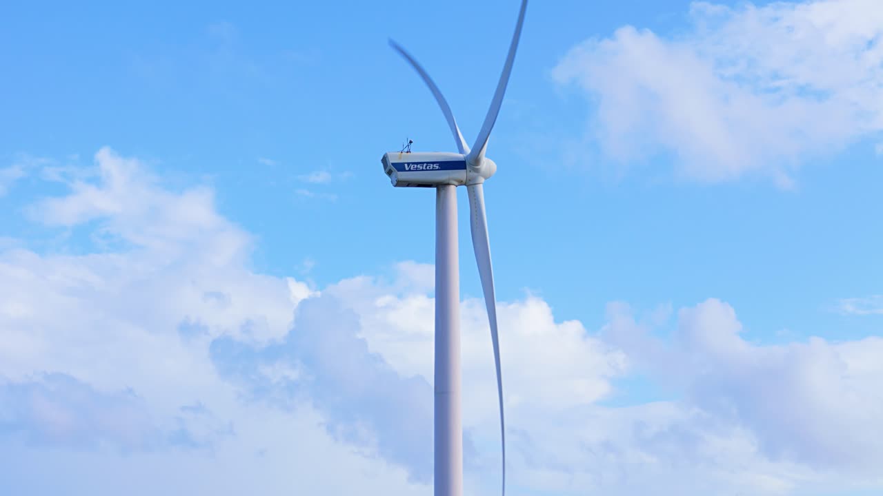 Side View Of Large Windmill Turbine Blades Spinning Against Blue Sky ...