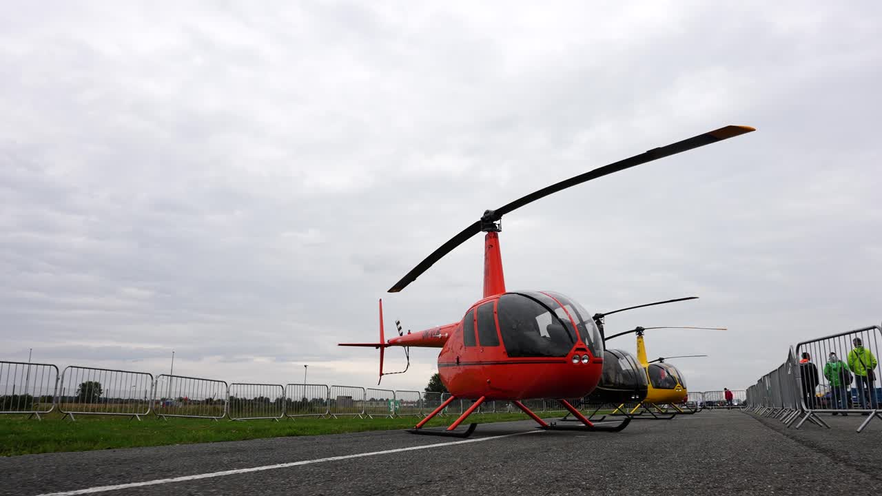 Light Helicopters Parked Behind Fence On Airport Ramp During Airshow ...