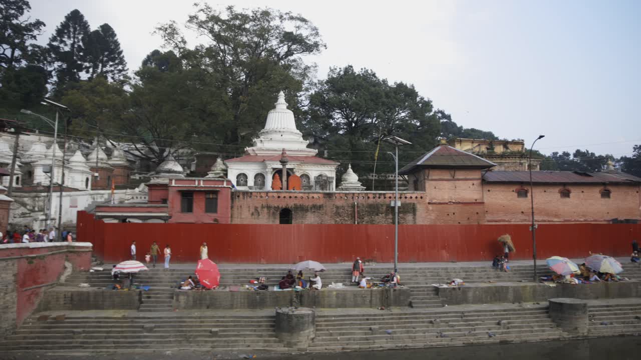 Rightward Pan Of Pashupatinath Temple, With A Cremation Ceremony Taking ...