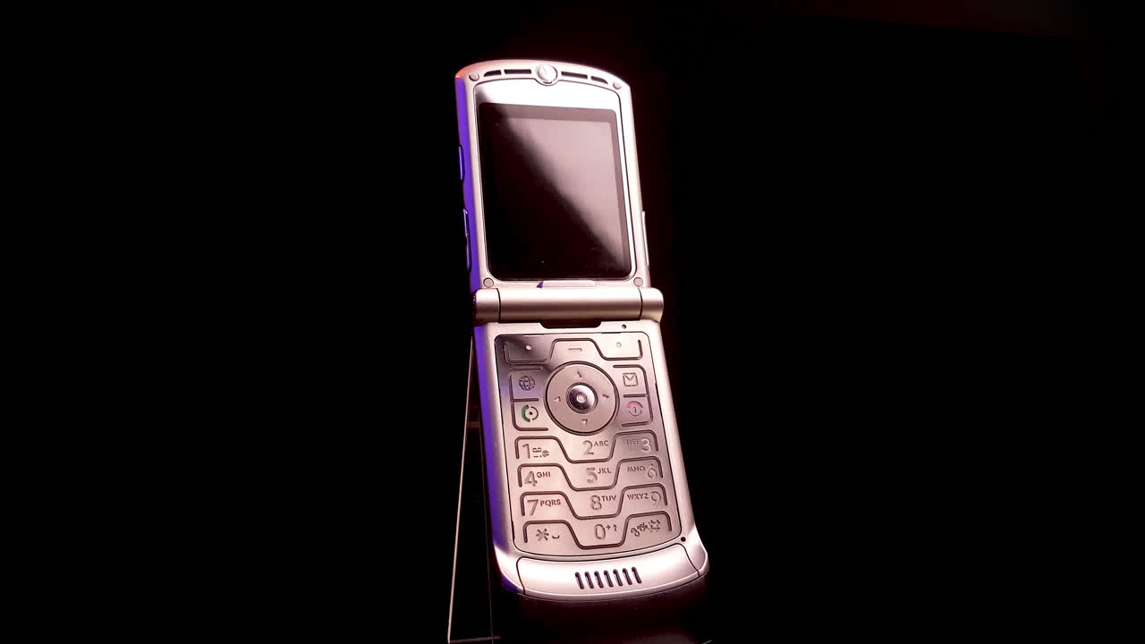 Spinning Motorola Razr V3 Opened Flip Mobile Phone On Black Background ...