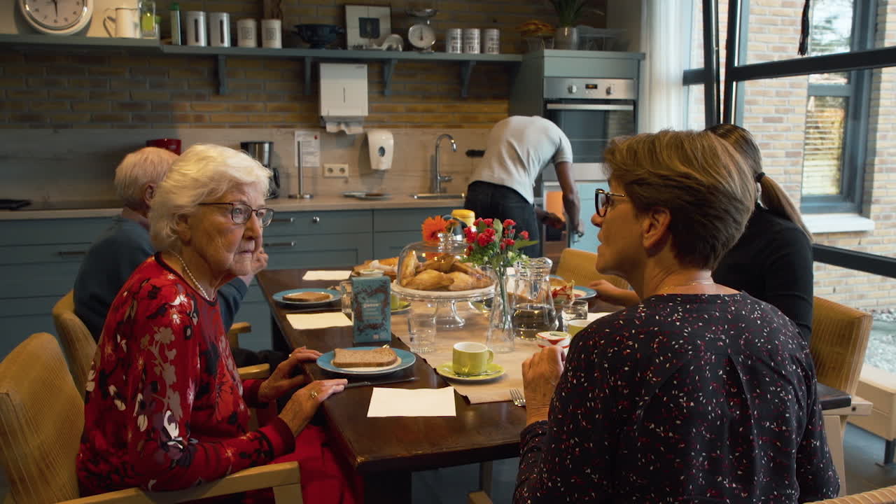 Retirement Home Scene With Caretakers And Elderly People Talking In ...