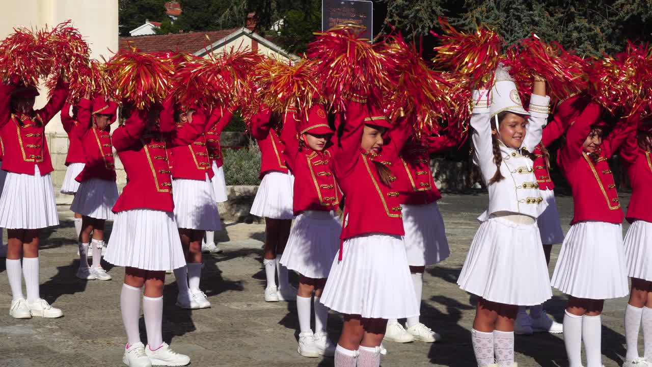 Cute Majorette Girls In Red Uniforms Performing With Pom Poms On City ...