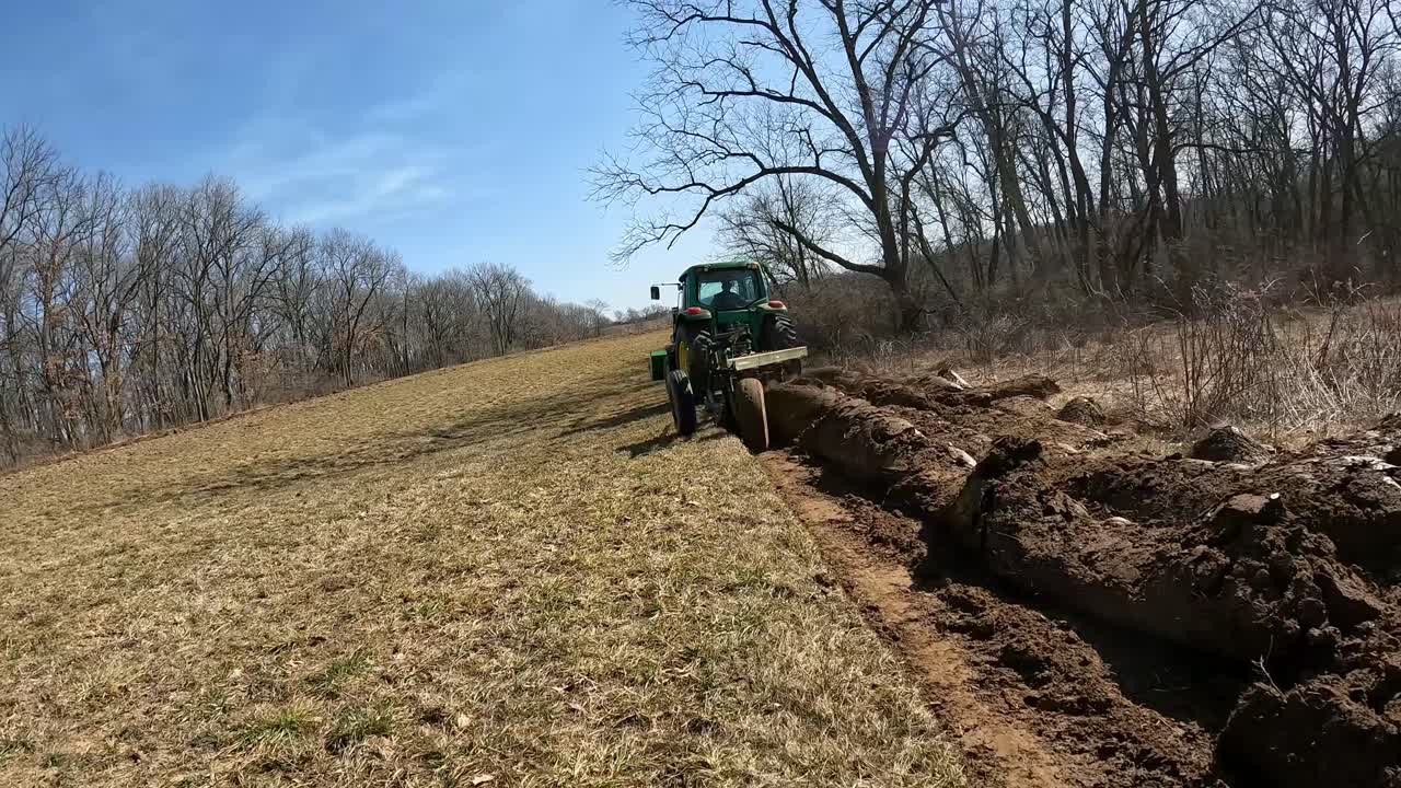 Low Angle View Of John Deere Tractor With An Attached Loader Is Towing ...