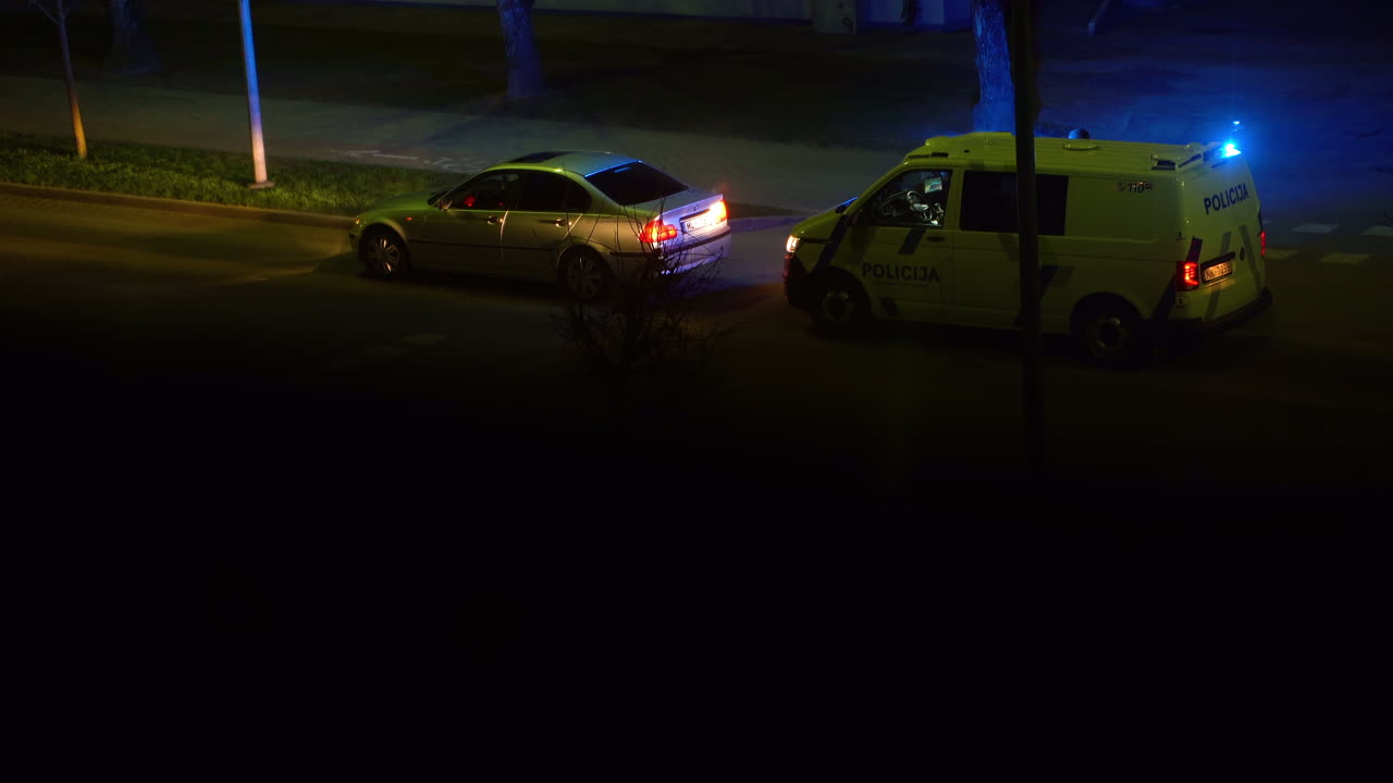 Policeman Walks Back To His Car During Traffic Stop At Night Free Stock