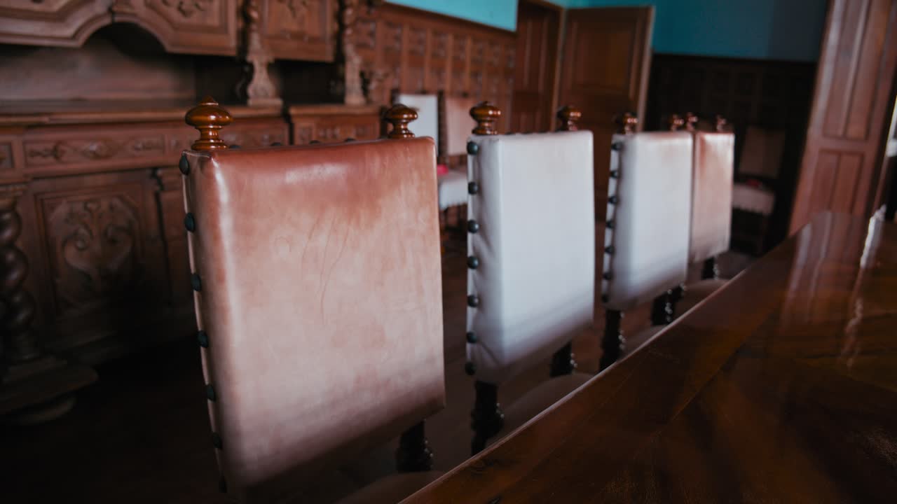 Row Of Antique Leather Backed Chairs Facing An Intricately Carved ...