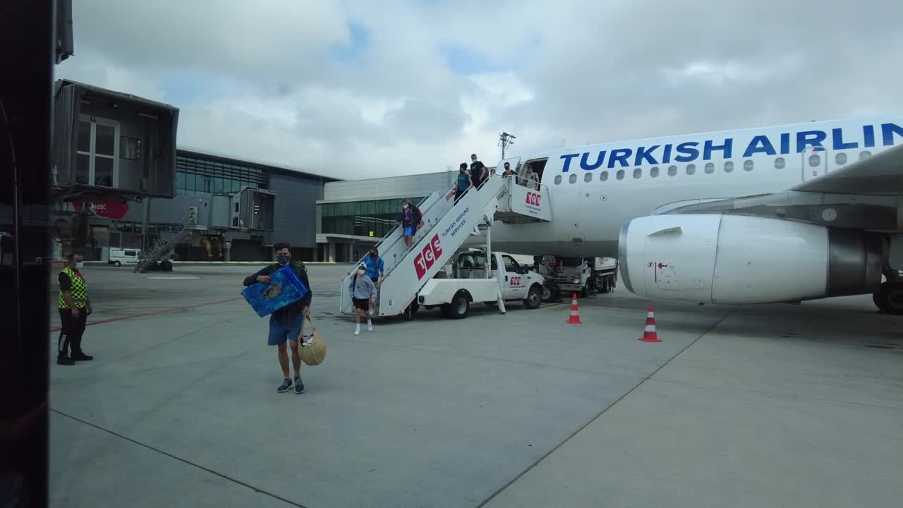 Passengers Boarding A Turkish Airlines Plane Via Stairs On A Cloudy Day ...