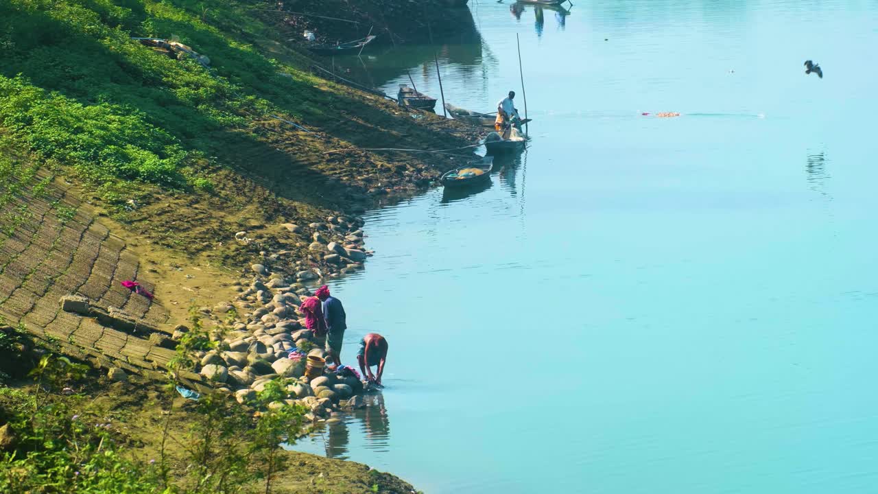 Villagers In A Rural Area Of Bangladesh, Washing Clothes On Riverbank ...