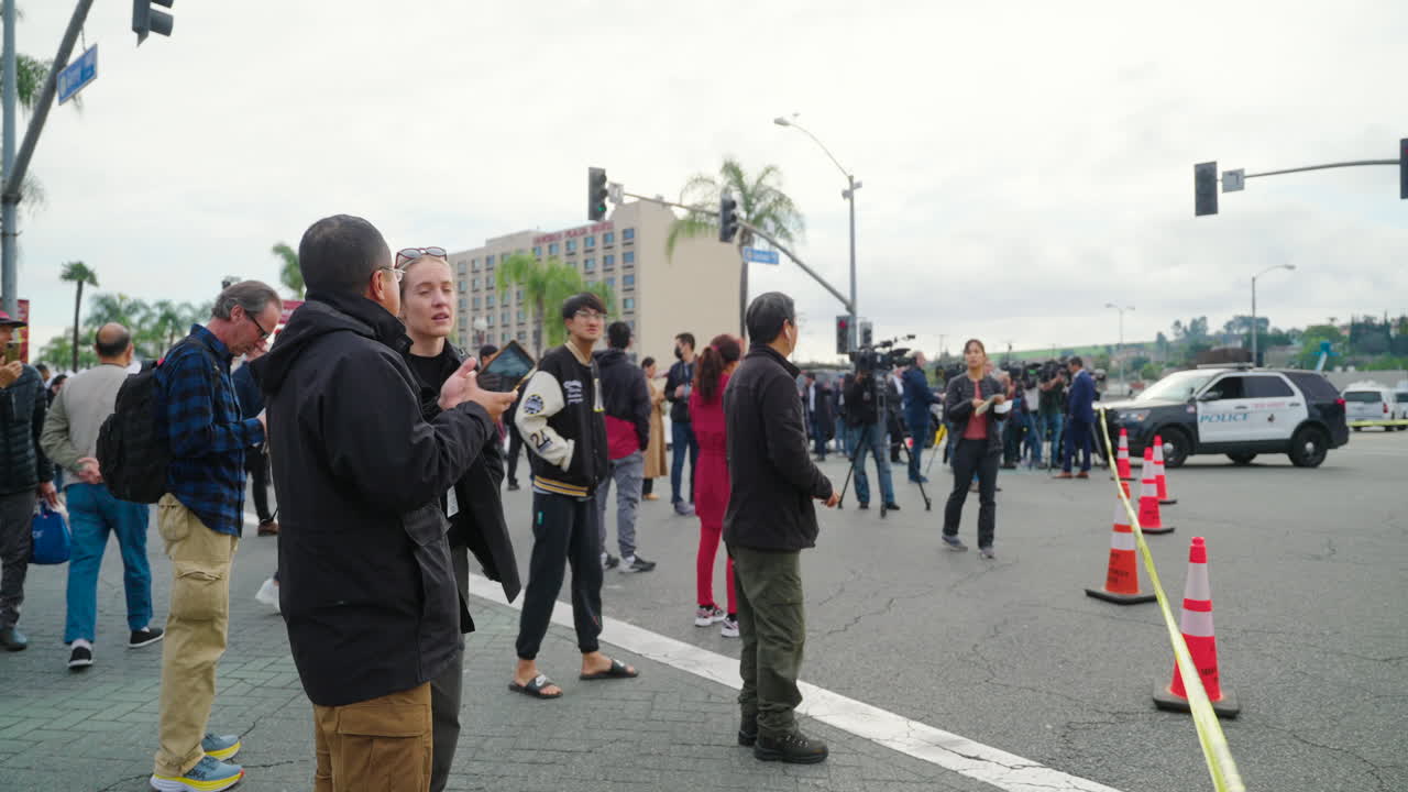 A Crowd Of Bystandrs, Reporters, And Police Watch The Star Ballroom ...