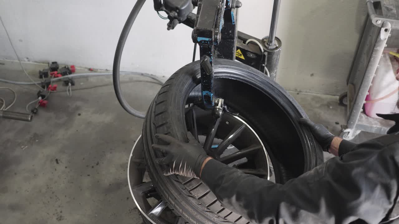 Male Car Mechanic Replacing The Tires With Help Of A Machine Free Stock ...