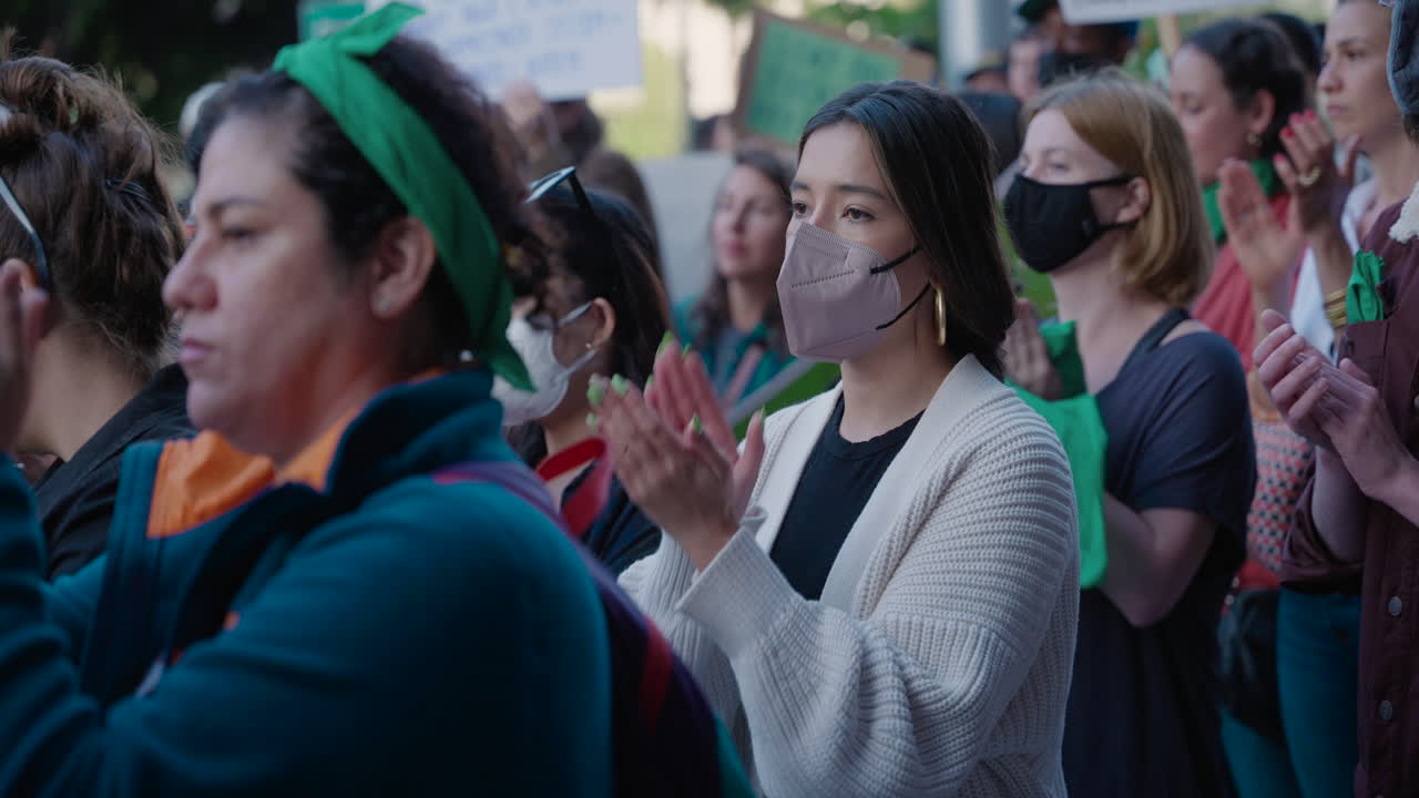 Women With Green Bandanas Clap And Hold Signs In A Crowd Of Pro Choice ...