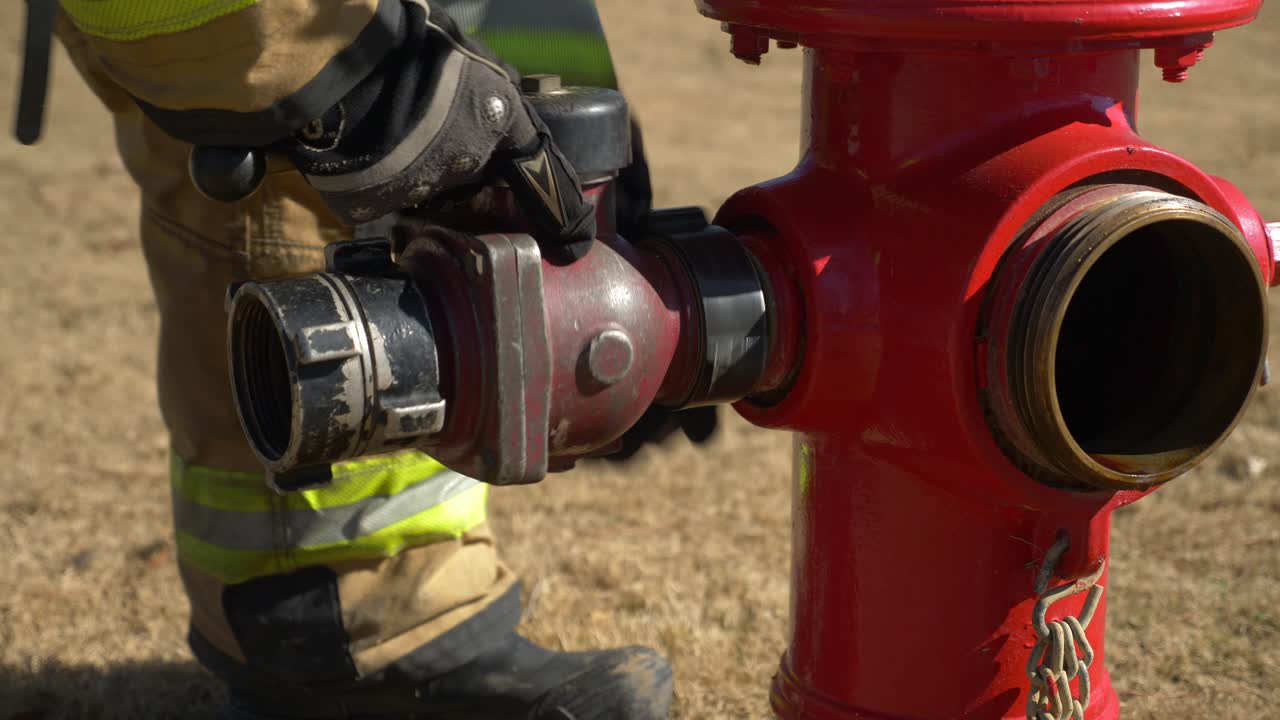 Firefighter Works On Preparing A Fire Hydrant To Hook Up A Fire Host To ...