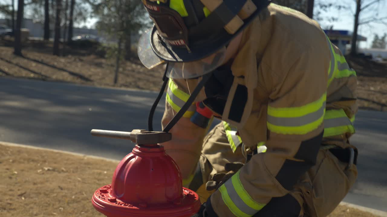 Firefighter Works On Preparing A Fire Hydrant To Hook Up A Fire Host To ...