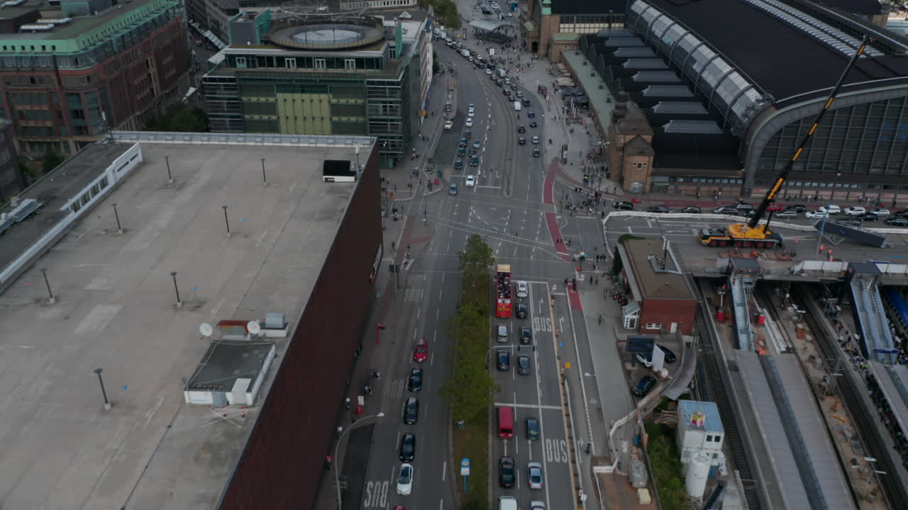 Forwards Fly Above Busy Street Around Hamburg Hauptbahnhof. Tilt Up ...