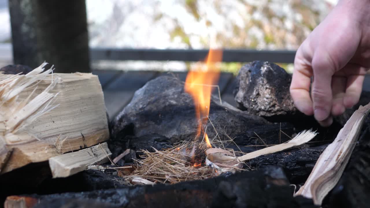 Close Up Shot Of Man Starting A Wood Fire By Lighting A Tinder Bundle ...