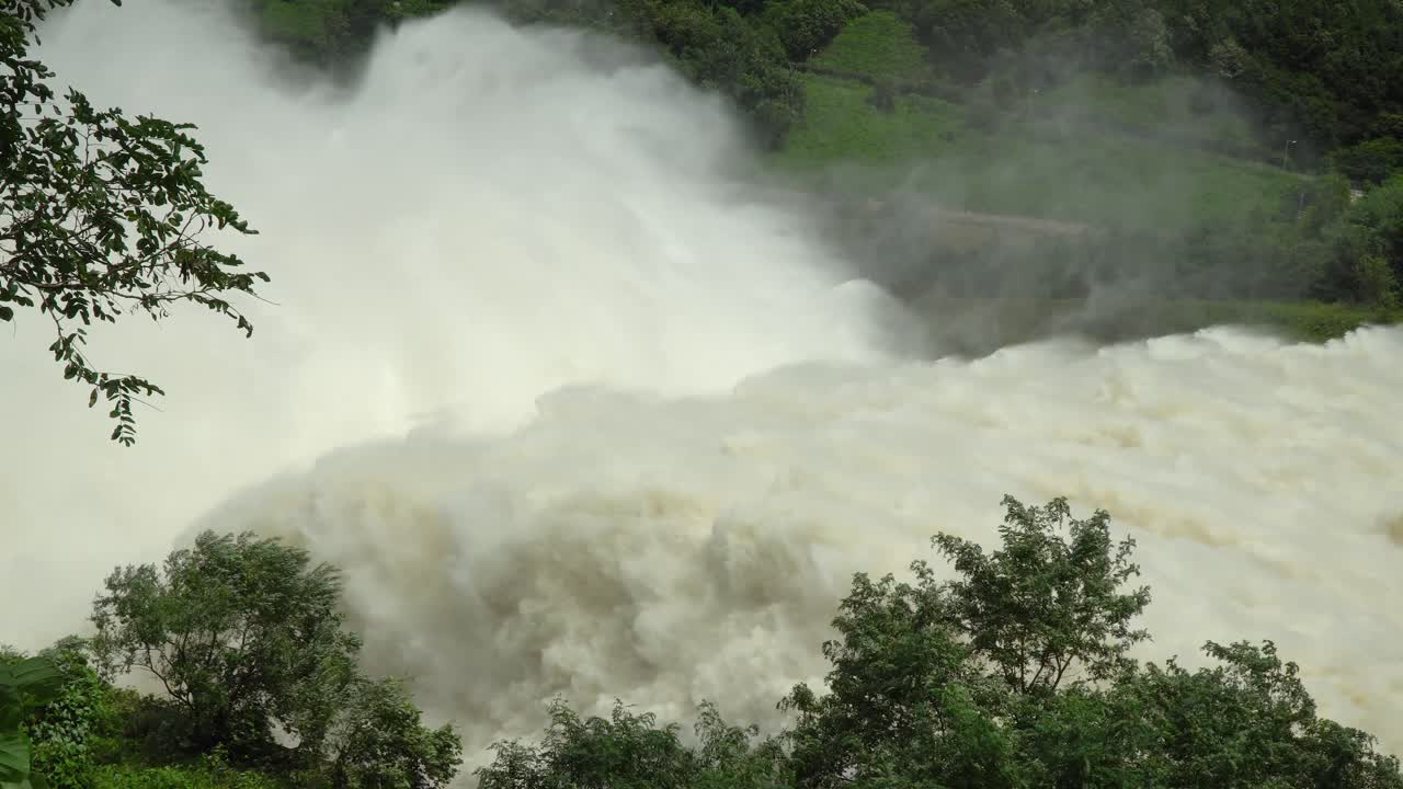 Large Amounts Of Water Flow Off Spillway Into Valley Showing Powerful ...