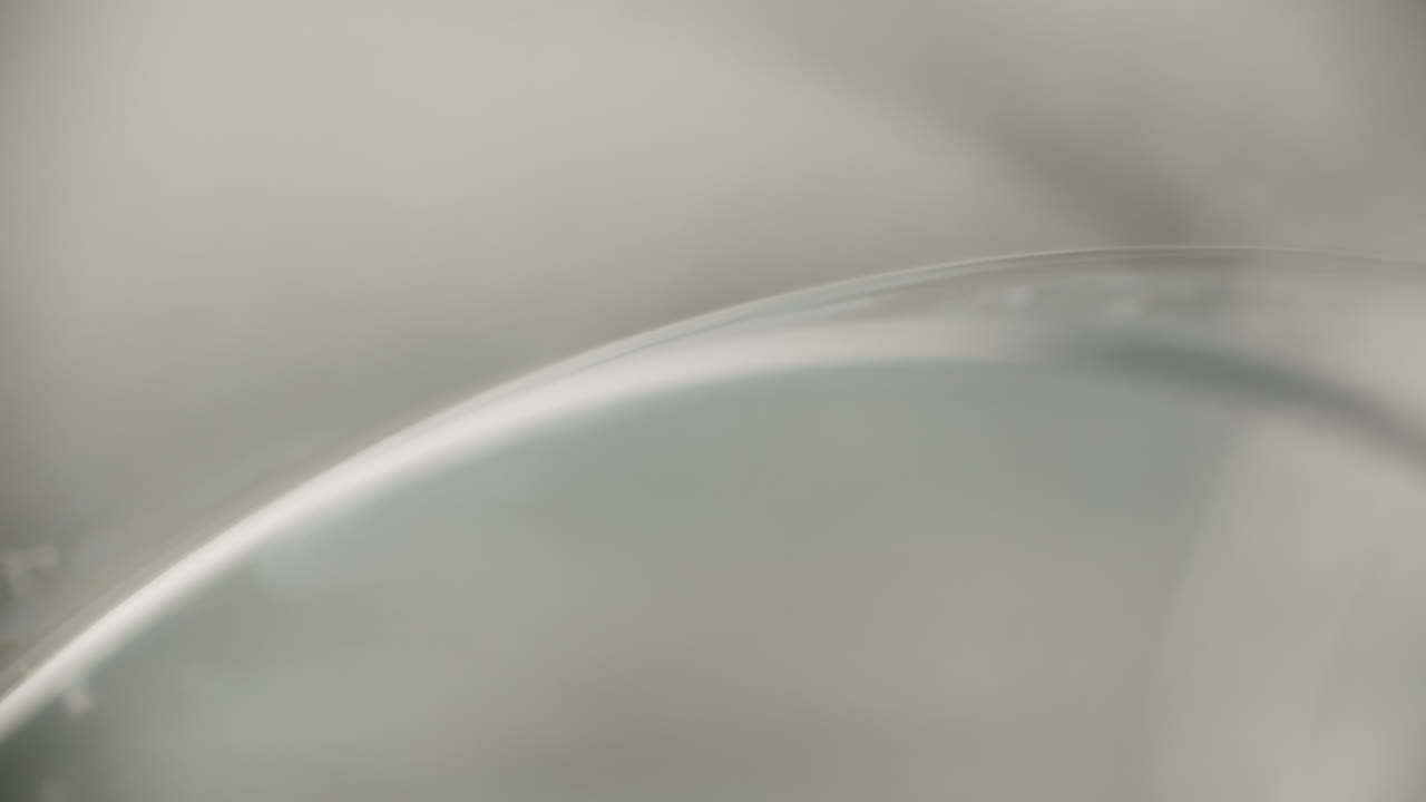 Premium stock video - Macro shot of slow moving liquid on a sphere