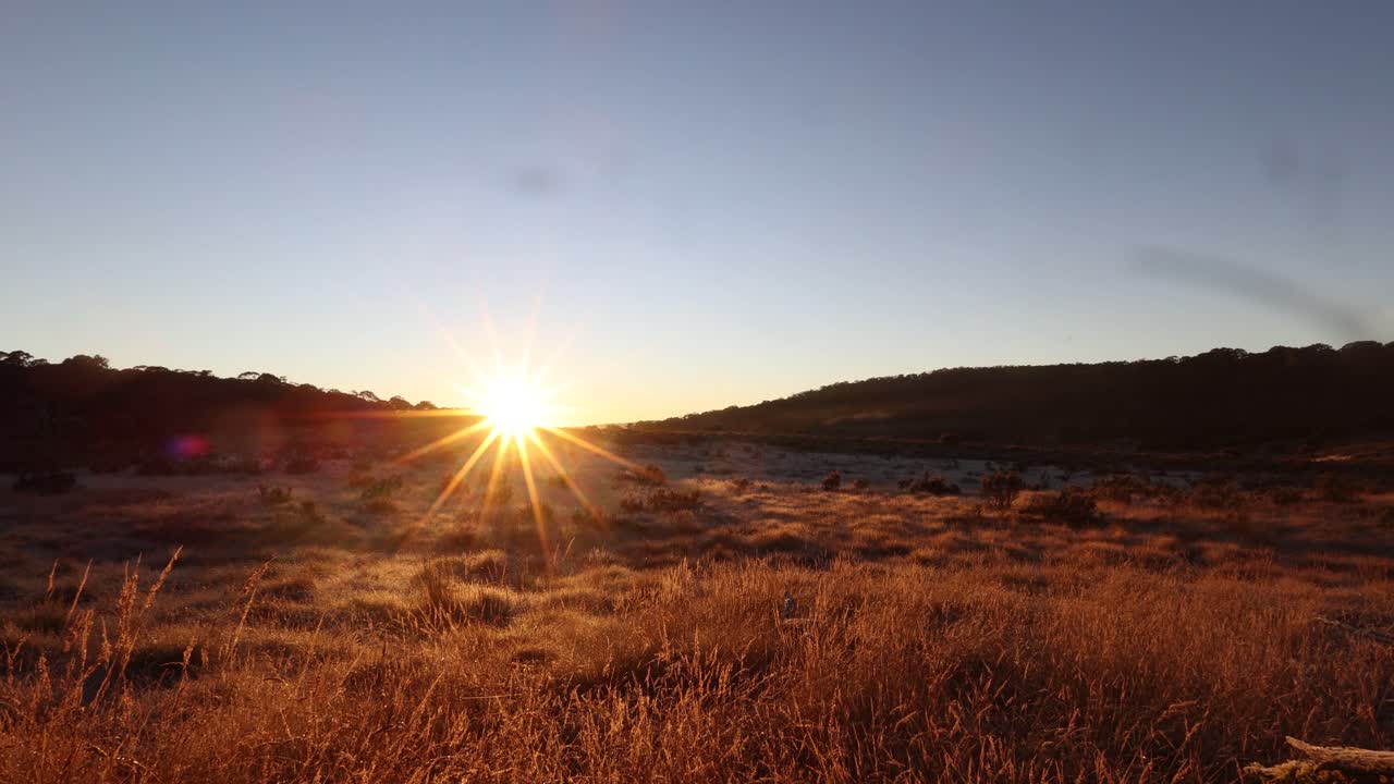 Premium stock video - Morning sunrise peaking over the horizon over the ...