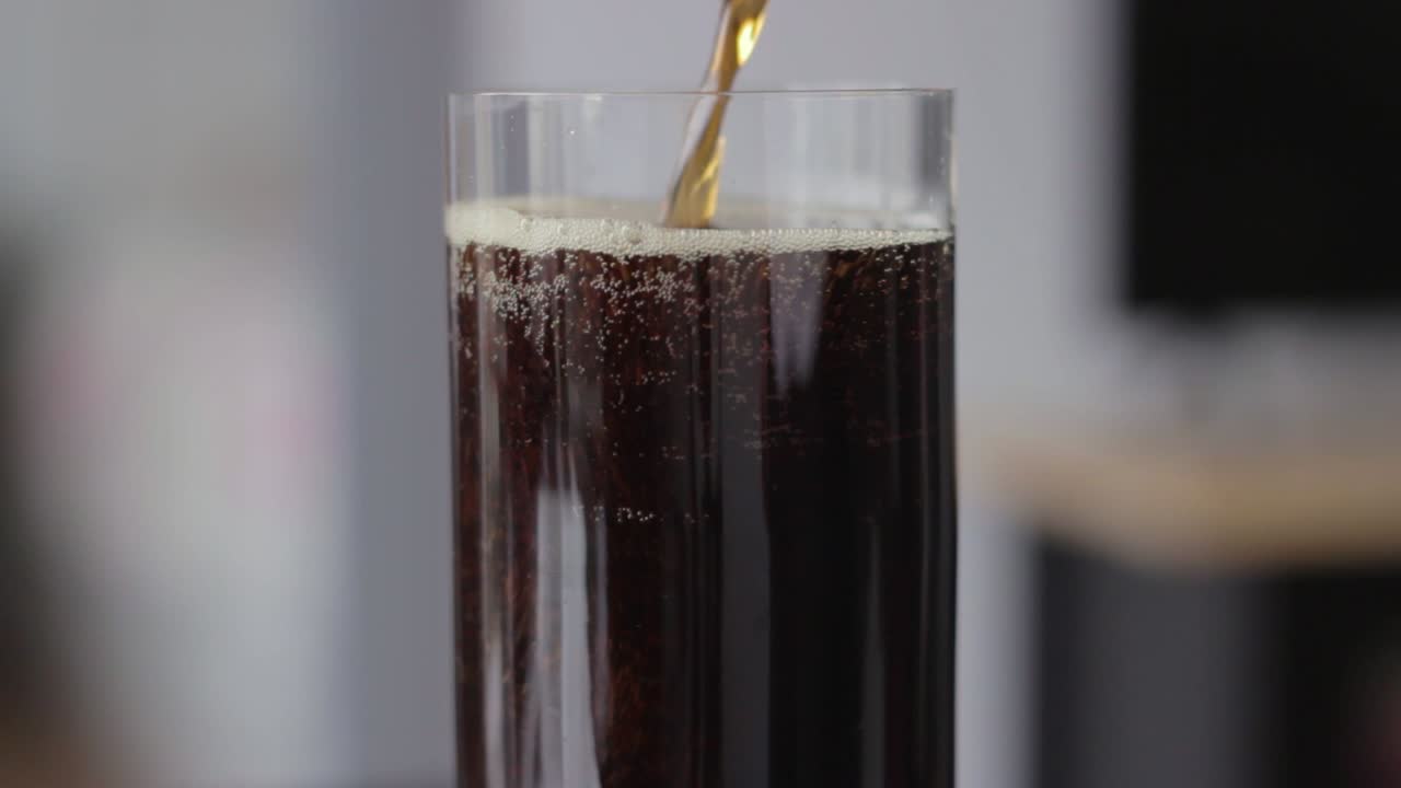 Premium stock video - Closeup of glass being filled with sparkling coke ...