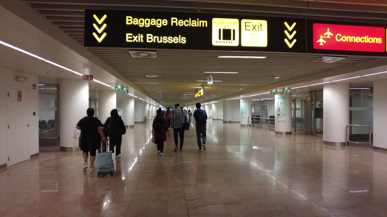 Passengers At Brussels Airport Walking In Arrival And Transit Area ...