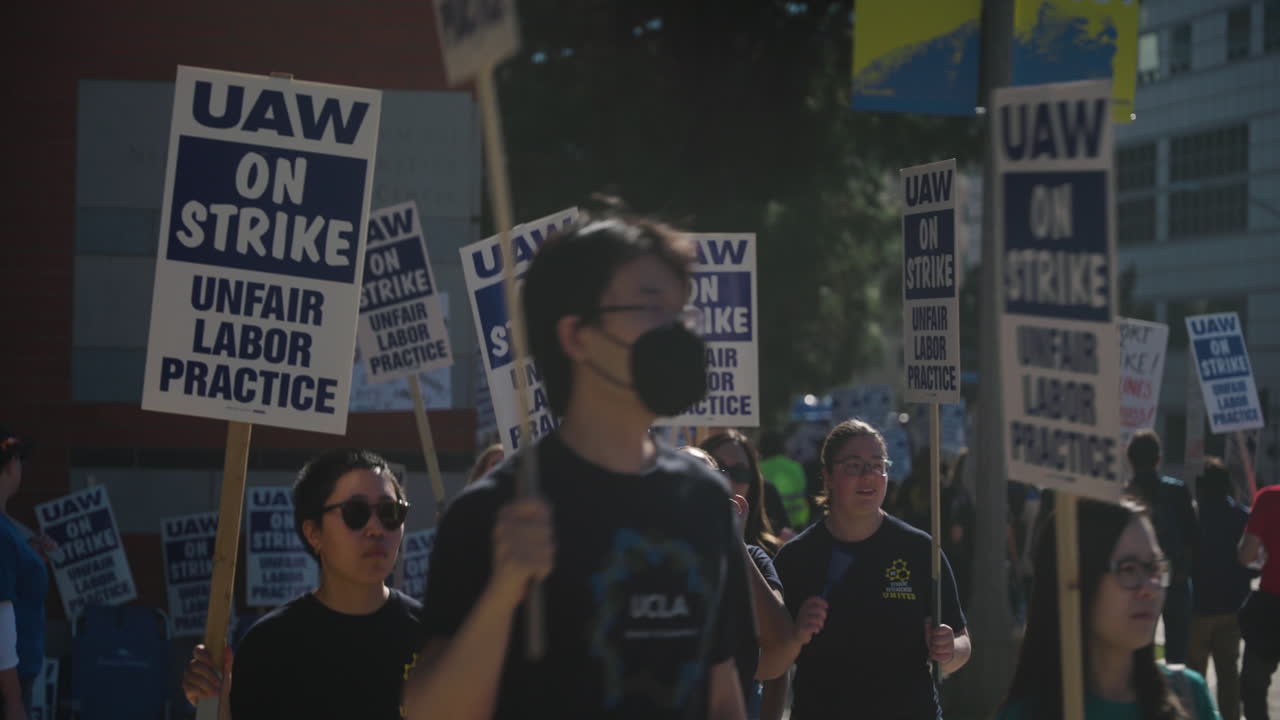 UC Academic Workers Holding UAW On Strike Signs And Walking In Circles ...