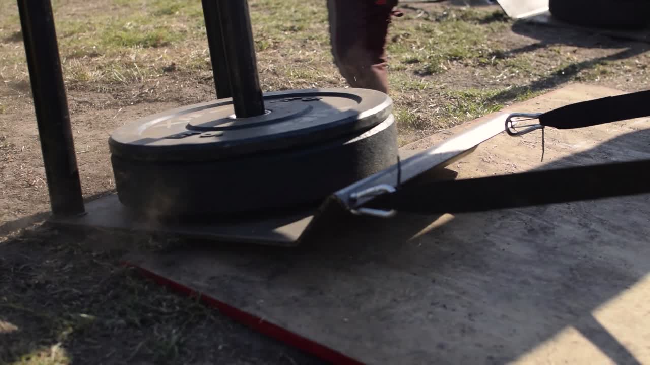 Cross Fits Athlete Pulling A Weighted Sled Drag Across The Finish Line ...