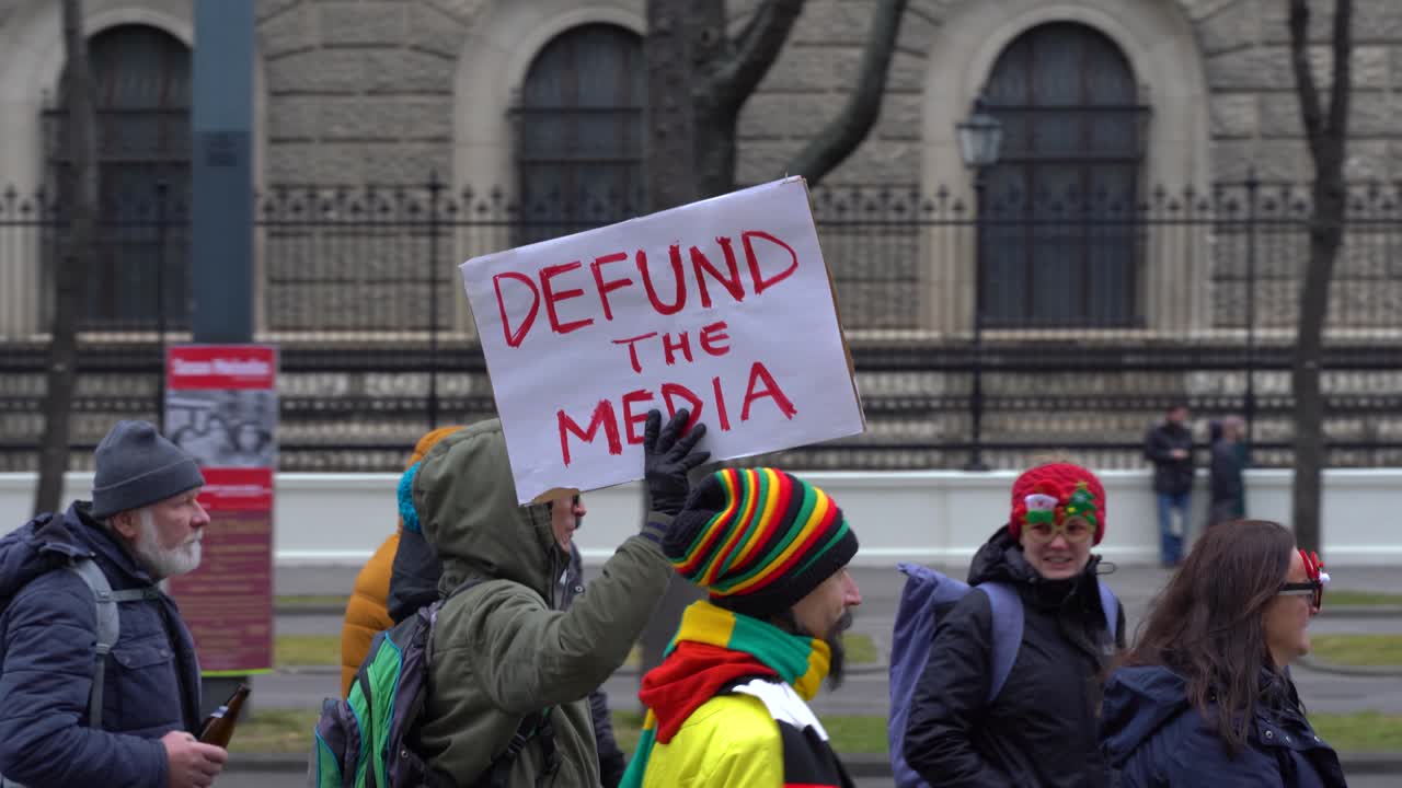 Man Holding Up A Defund The Media Sign During Corona Protests Free ...