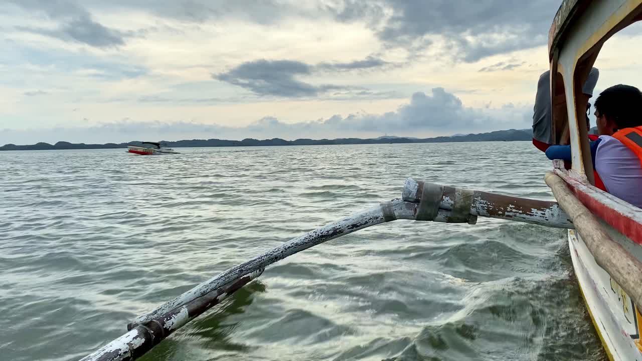 Side Of Bangka Boat Carrying Tourists Sailing Through Grey Tropical ...