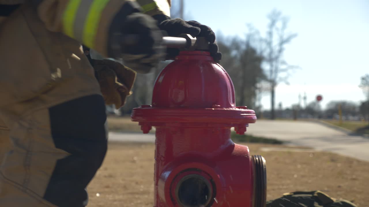 Firefighter Works On Preparing A Fire Hydrant To Hook Up A Fire Host To ...