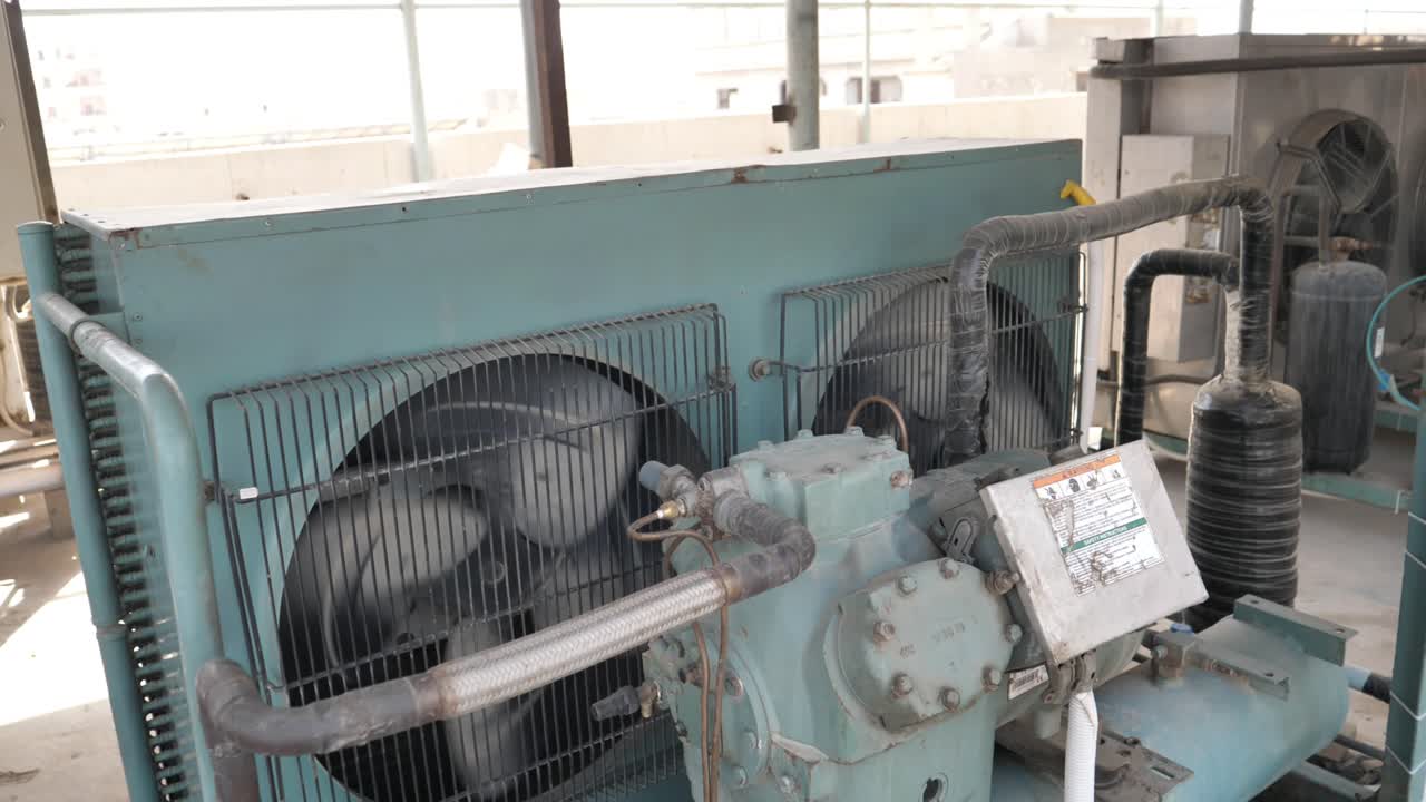 Two Spinning Giant Enclosed Industrial Fans Inside Factory In Pakistan ...
