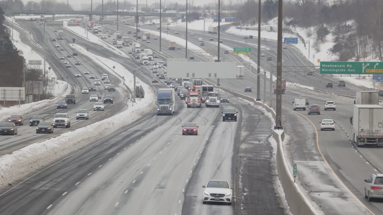 Large Convoy Of Transport Trucks Heading East On 5-lane Highway ...