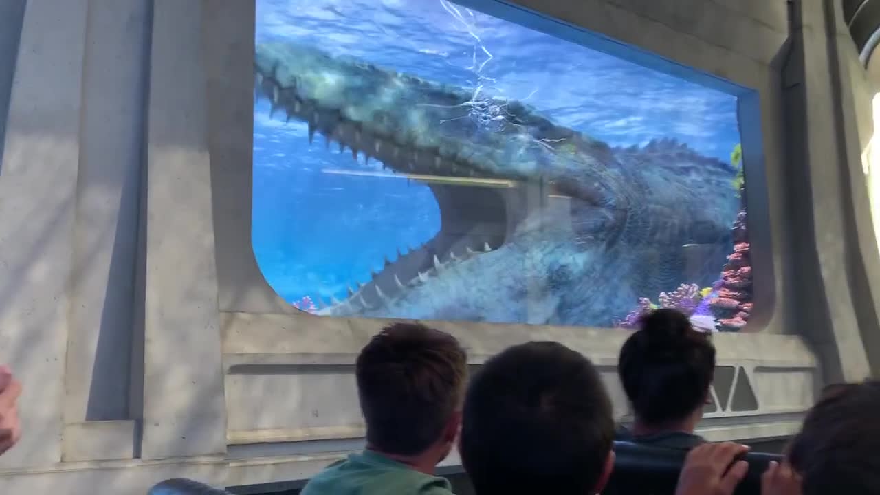 A Massive Mosasaurus Swimming In A Large Underwater Tank Speeds Up And ...