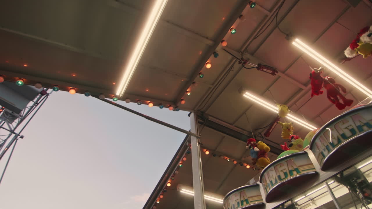 Carnival Game Stand Ceiling With Hanging Prizes And Lights, Wide Shot ...