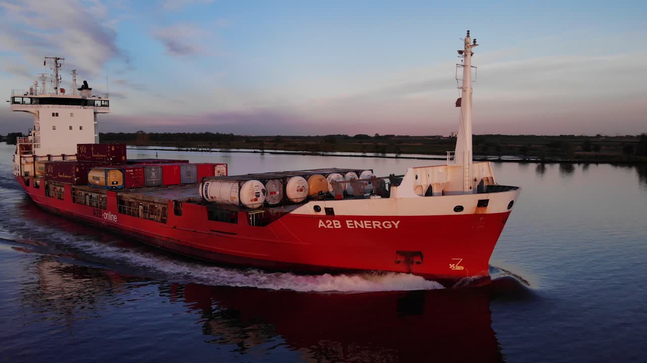 A2B Energy Vessel In Red Sailing Through Water Channel Carrying Freight ...