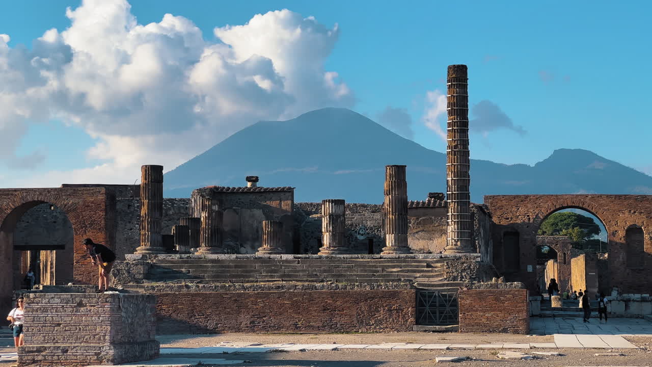 Wide Shot Showing Tourist Visiting Famous Old Ruin Of Pompeii With Epic ...