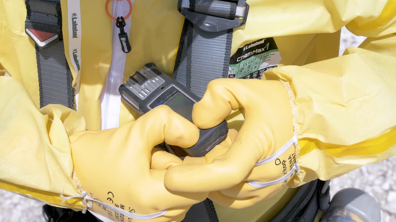Man In Yellow Hazmat Suit Checking Chemical Exposure Monitor, Close Up ...