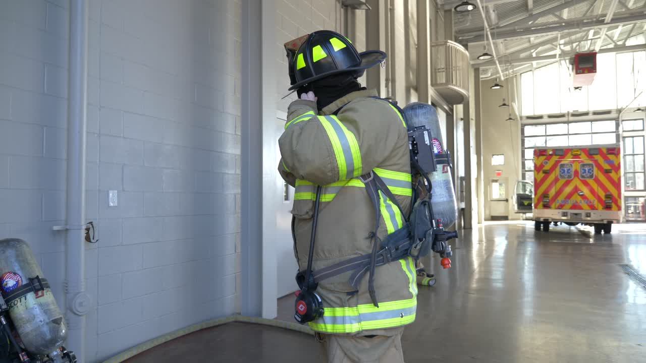 Firefighter Puts On Firefighting Gear With Air Tank And Helmet To Be ...