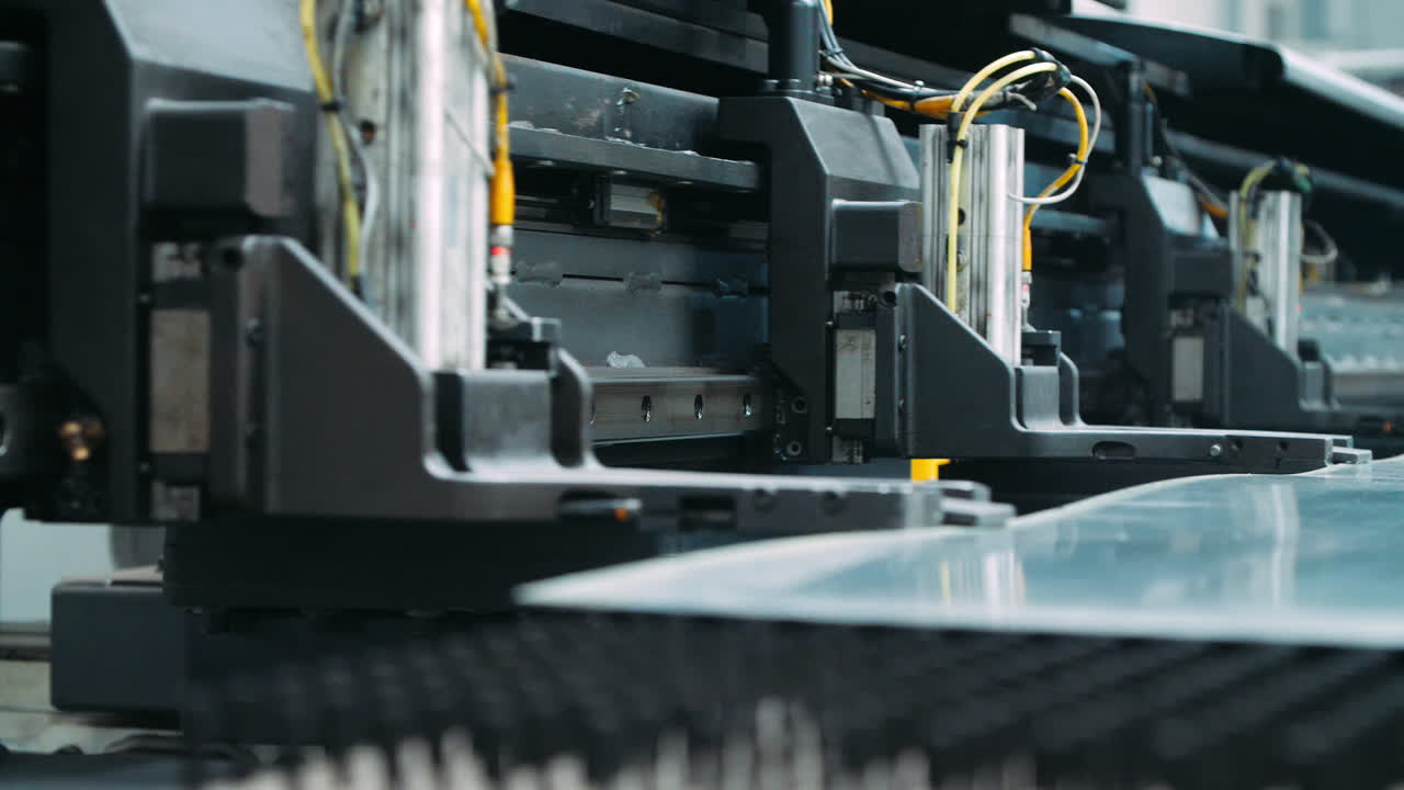 Premium stock video - Automatic feed mechanism in workshop of metal ...