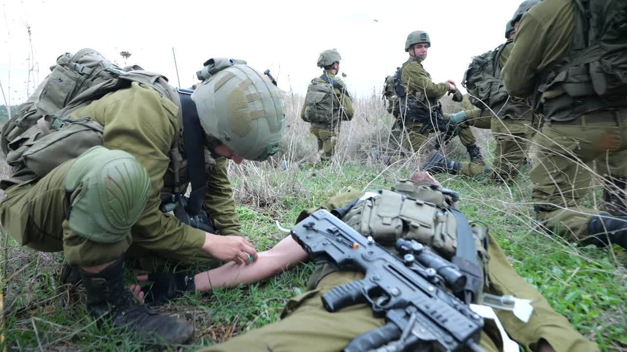 IDF Combat Medic Give First Aid To Wounded Infantry Soldier, Dolly In ...