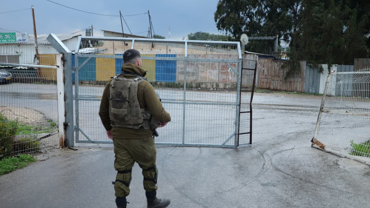 Israeli Army Soldier In Uniform And Body Armor Opens Gates In Rural ...