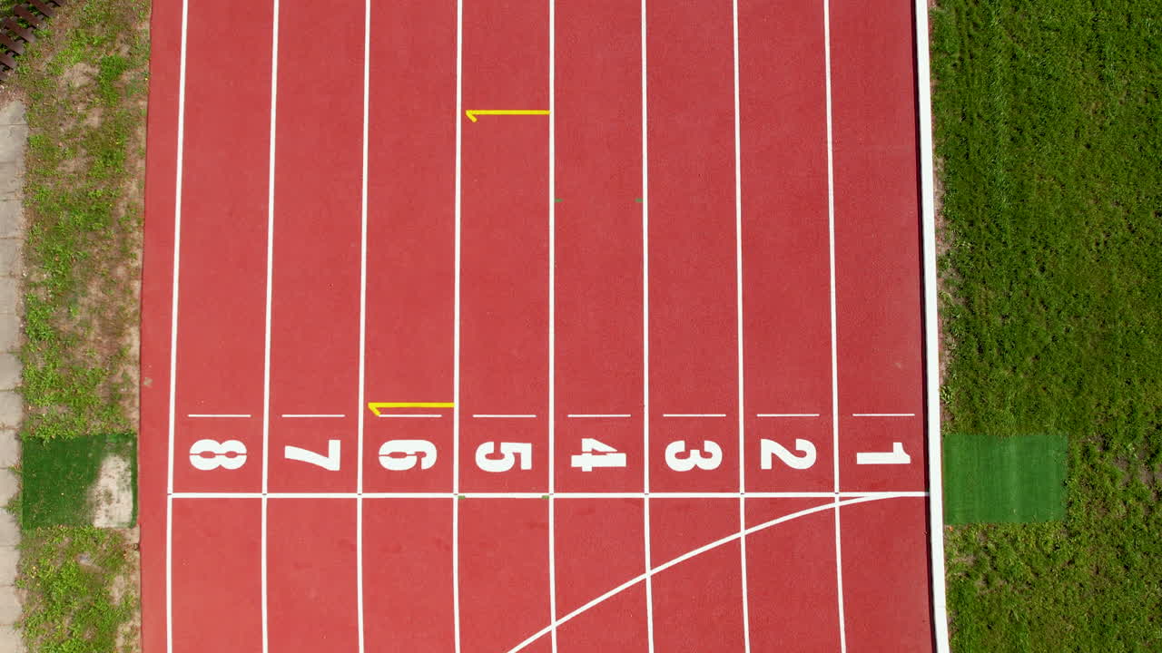 Top Down Aerial Over The Track And Numbered Starting Blocks At The ...