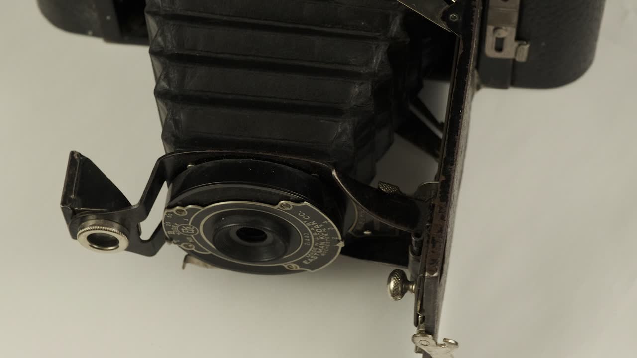 Old Vintage Folding Camera By Kodak With Bellows Out, Rotates On White ...