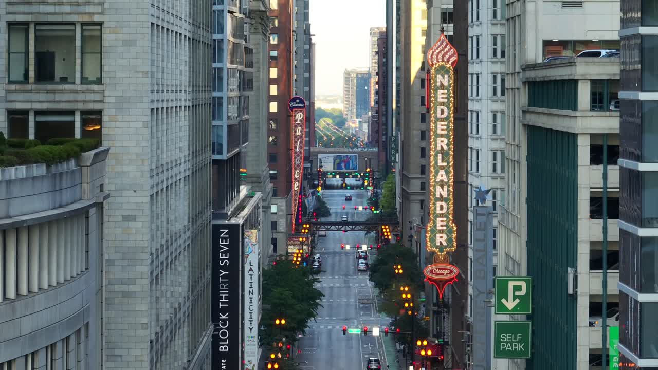 Downtown Chicago Street Lined By Towering Buildings, Neon Signs Like ...