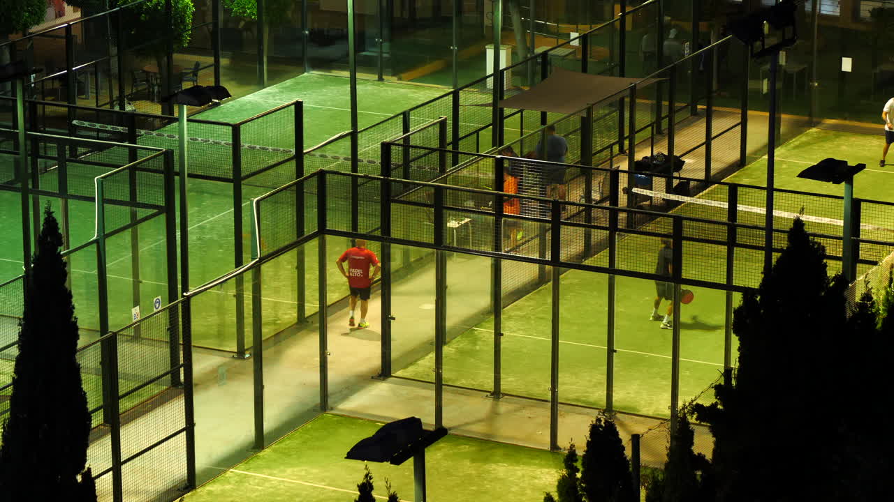 Padel Courts At Night With Players Playing On Lit Sport Fields, Static ...